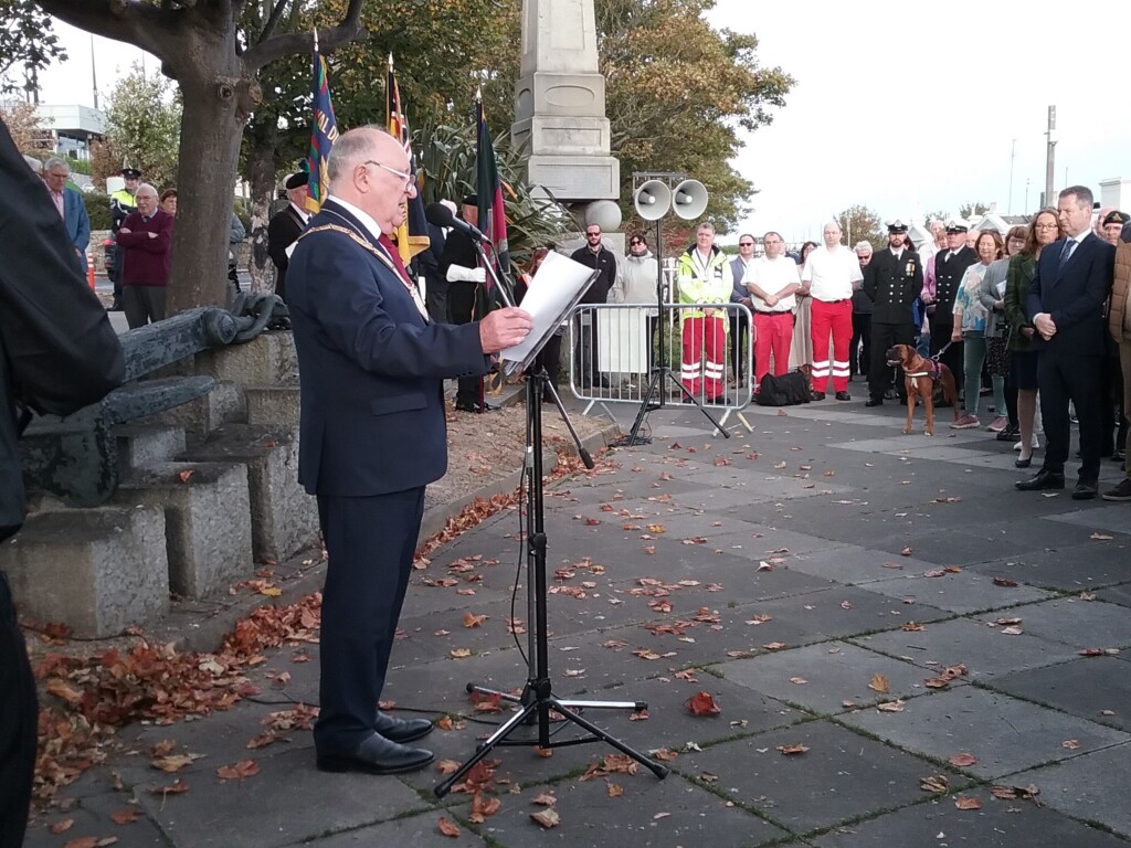 An Cathaoirleach addressing those present